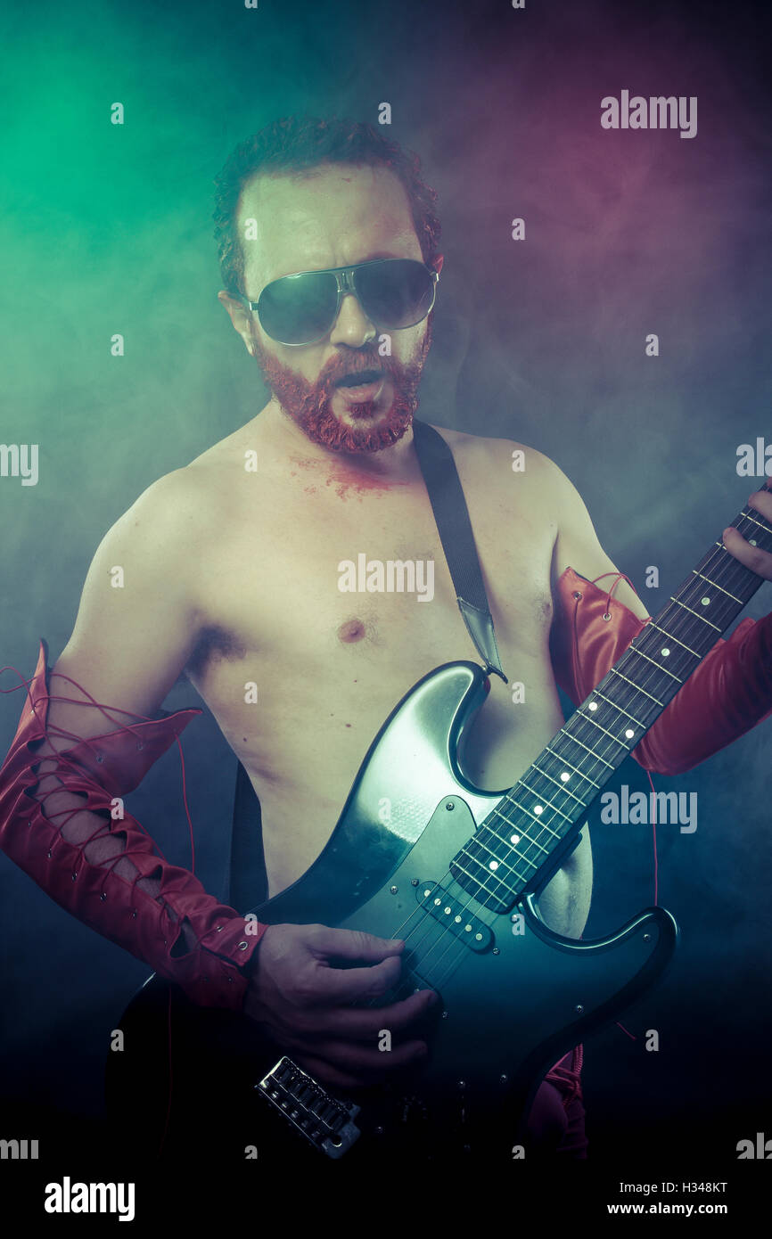 rocker man with electric guitar in a rock concert Stock Photo - Alamy