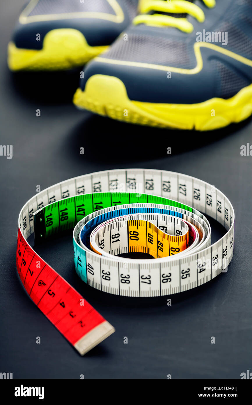 Sport shoes and measuring tape Stock Photo - Alamy