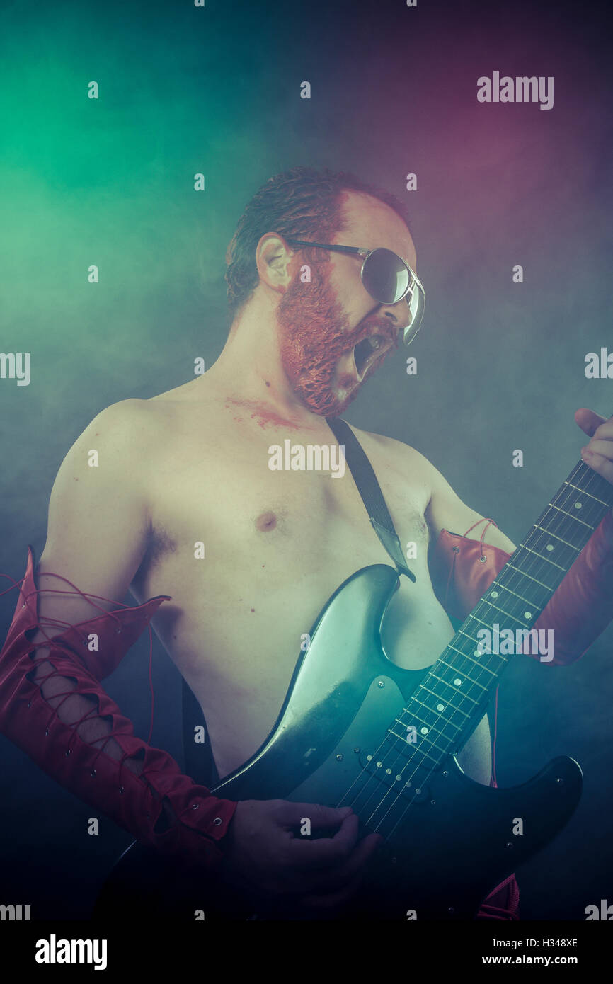 rocker man with electric guitar in a rock concert Stock Photo - Alamy