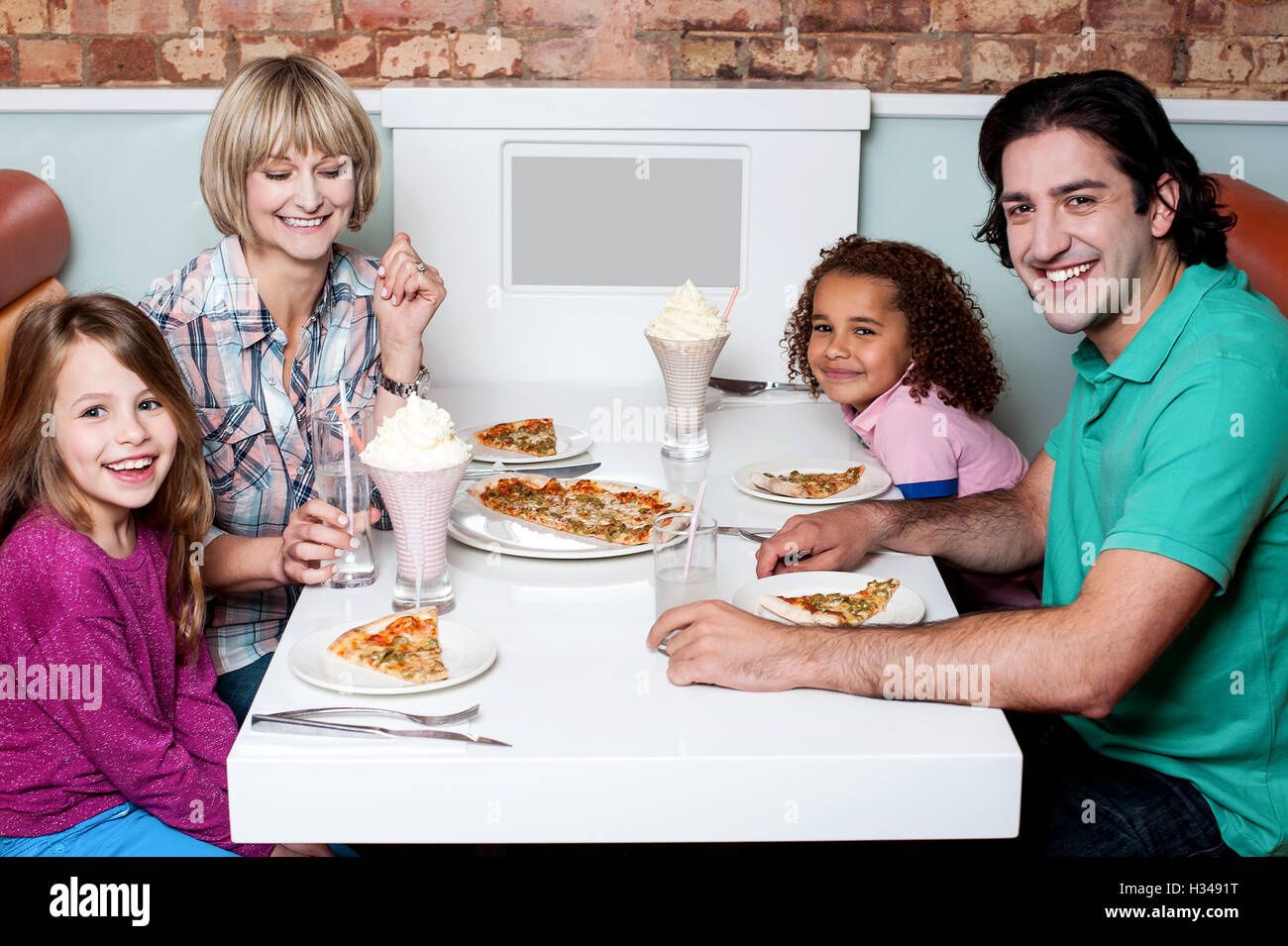 Family eating together in a restaurant Stock Photo - Alamy