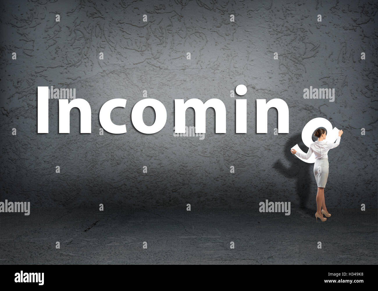 young businesswoman adds incomming word Stock Photo - Alamy