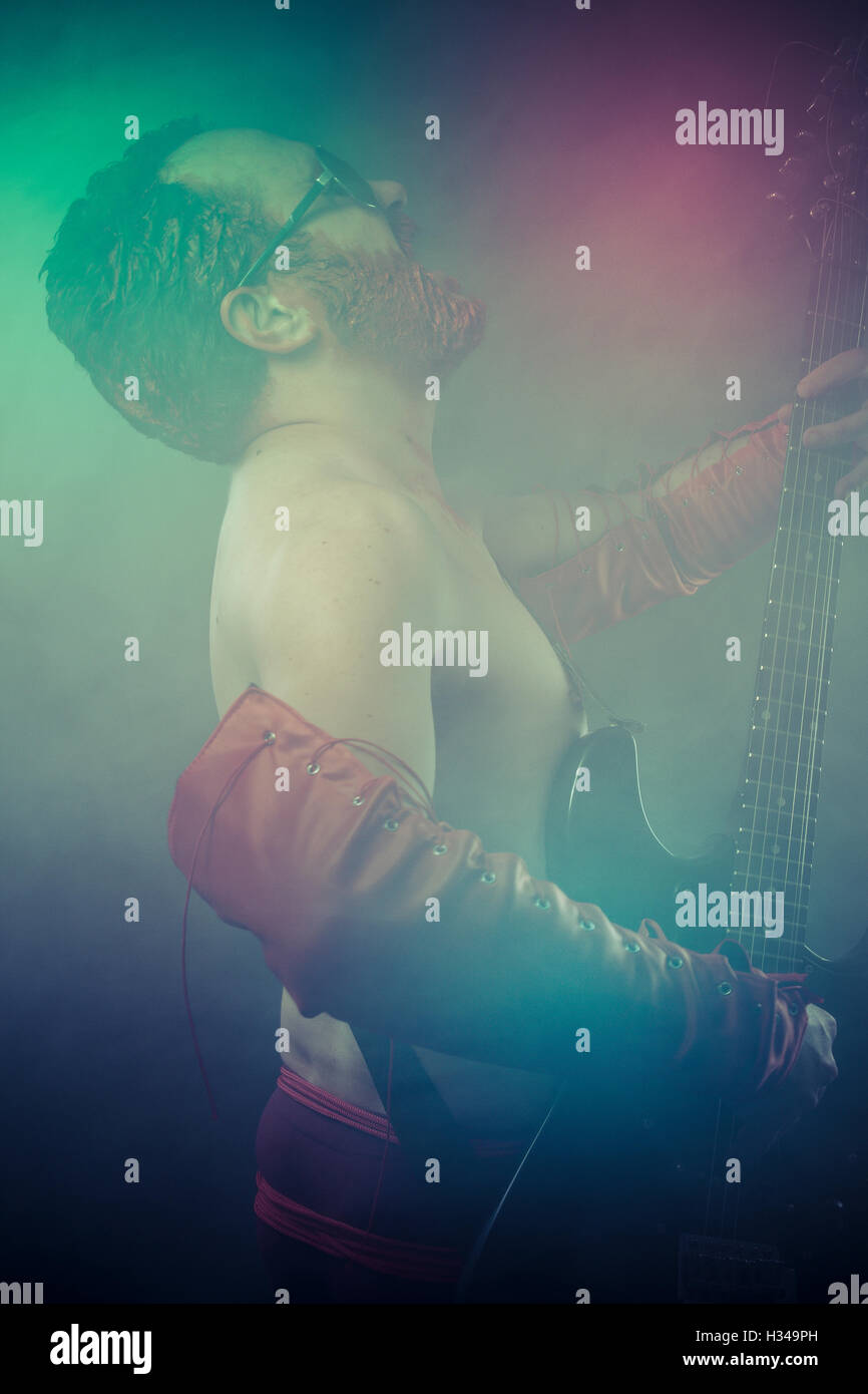 Punk, rocker man with electric guitar in a rock concert Stock Photo - Alamy