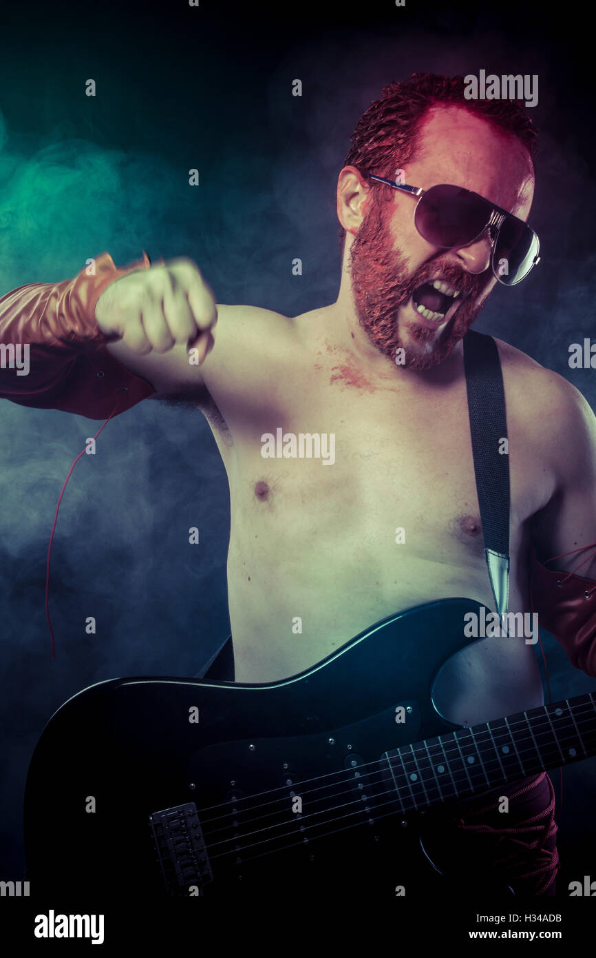 rocker man with electric guitar in a rock concert Stock Photo - Alamy