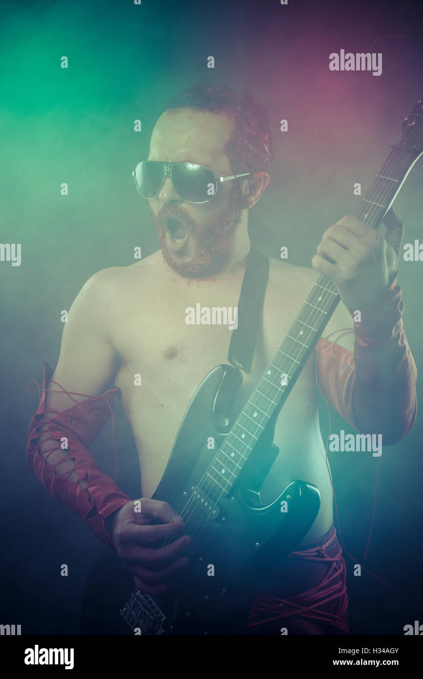Heavy, rocker man with electric guitar in a rock concert Stock Photo ...