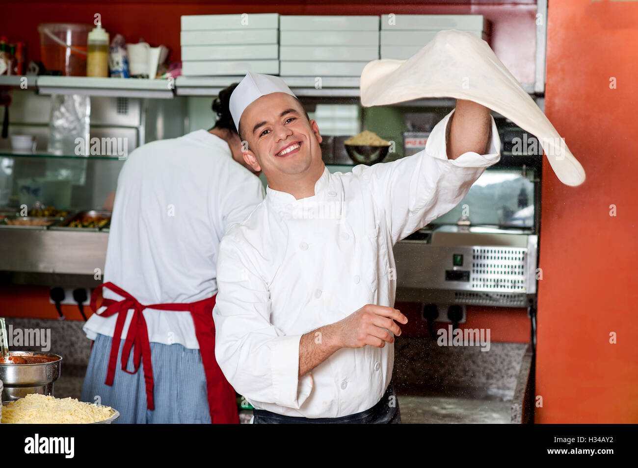 Chef throwing the pizza base dough Stock Photo - Alamy