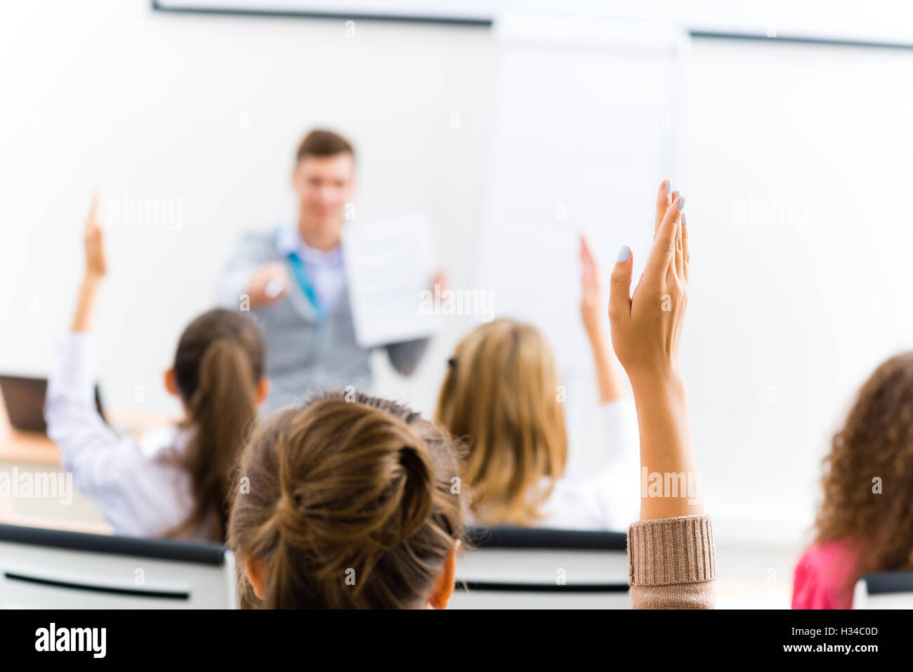 female hand raised in class Stock Photo - Alamy