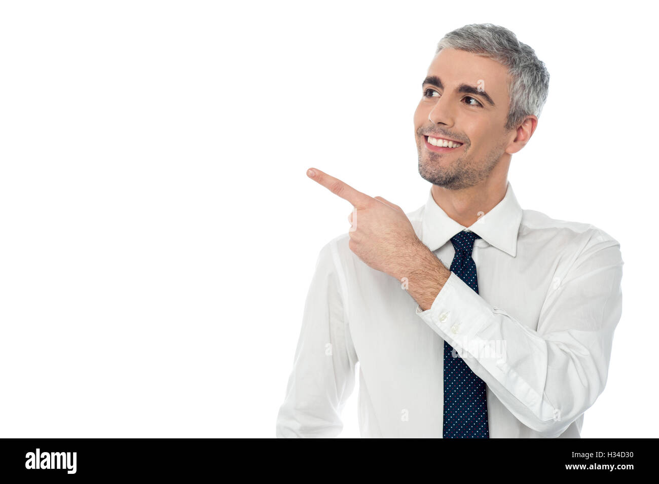 Happy man pointing at something Stock Photo - Alamy