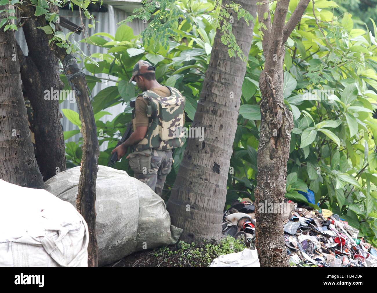 A Force One commando conducts a search and combing operation in a slum ...