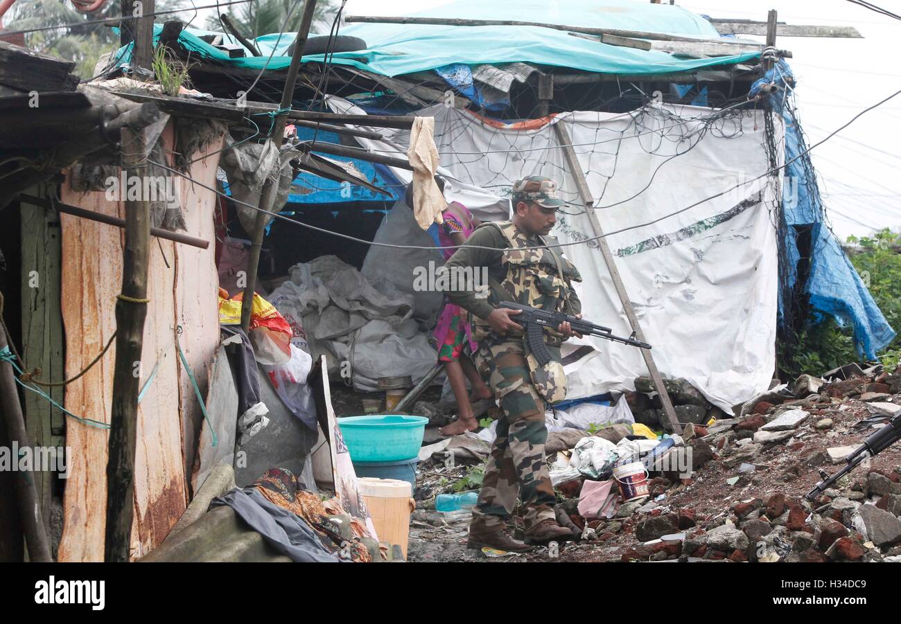 A Force One commando conducts a search and combing operation in a slum ...