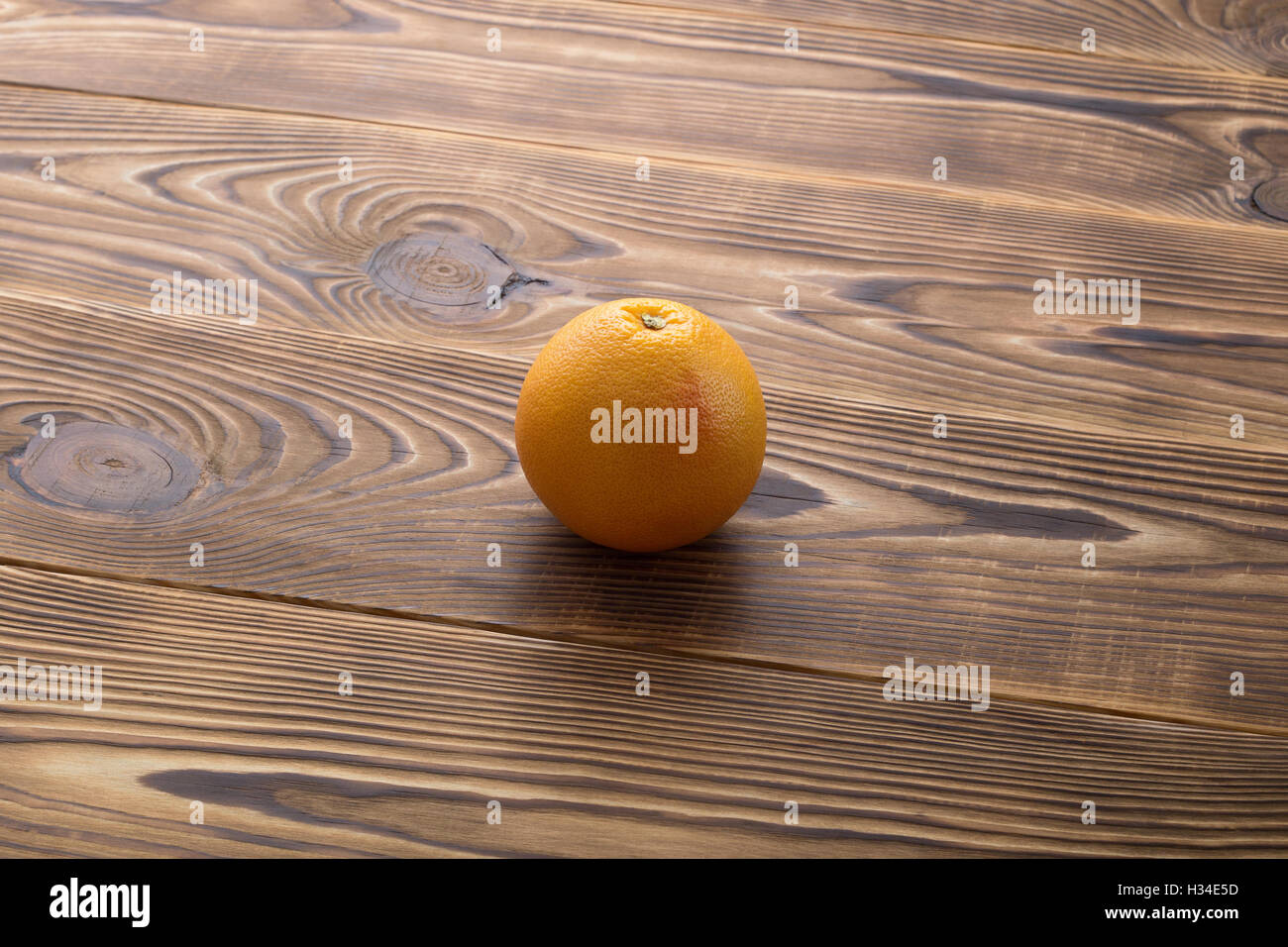 Perfect round fresh ripe grapefruit over brown natural aged wooden ...