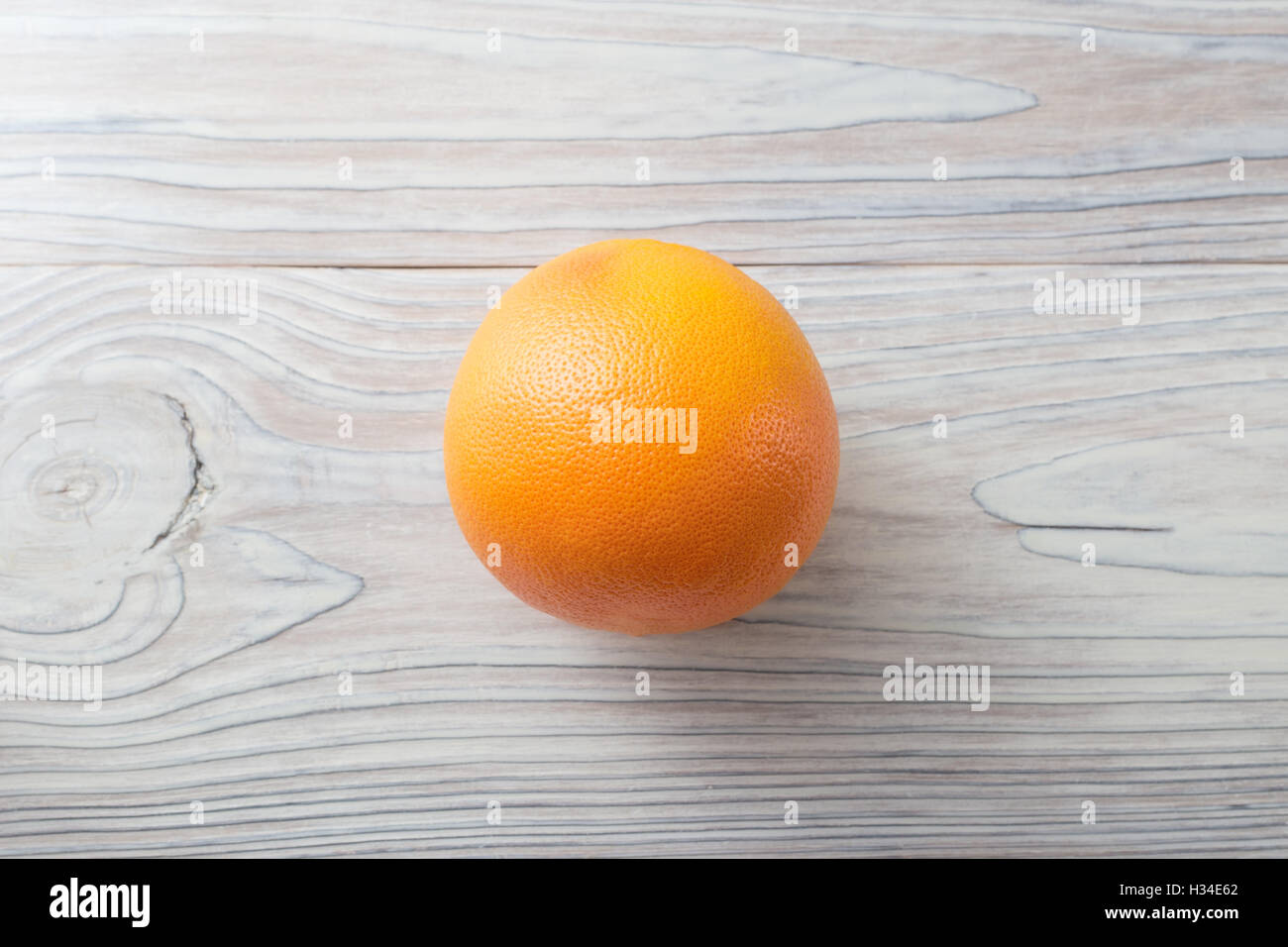Perfect round fresh ripe grapefruit over white natural aged wooden ...