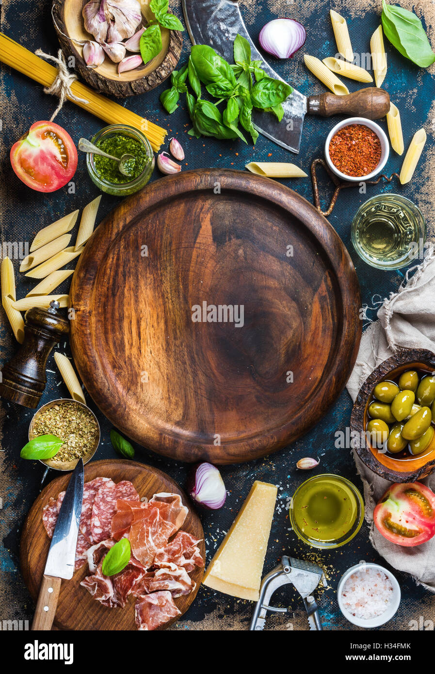 Italian food cooking ingredients on dark plywood background, copy space ...