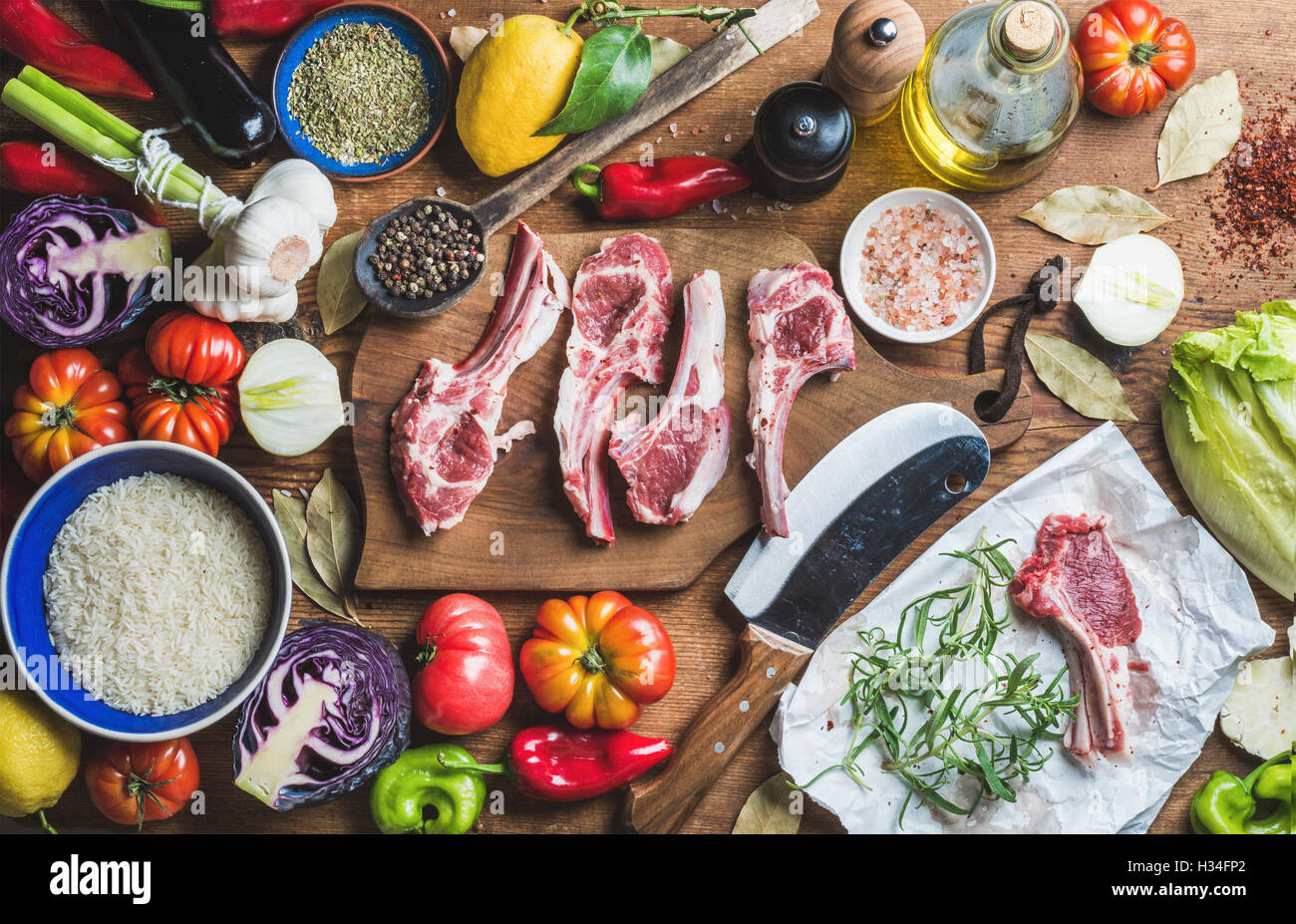 Raw uncooked lamb meat chops, rice, oil, spices and vegetables Stock ...