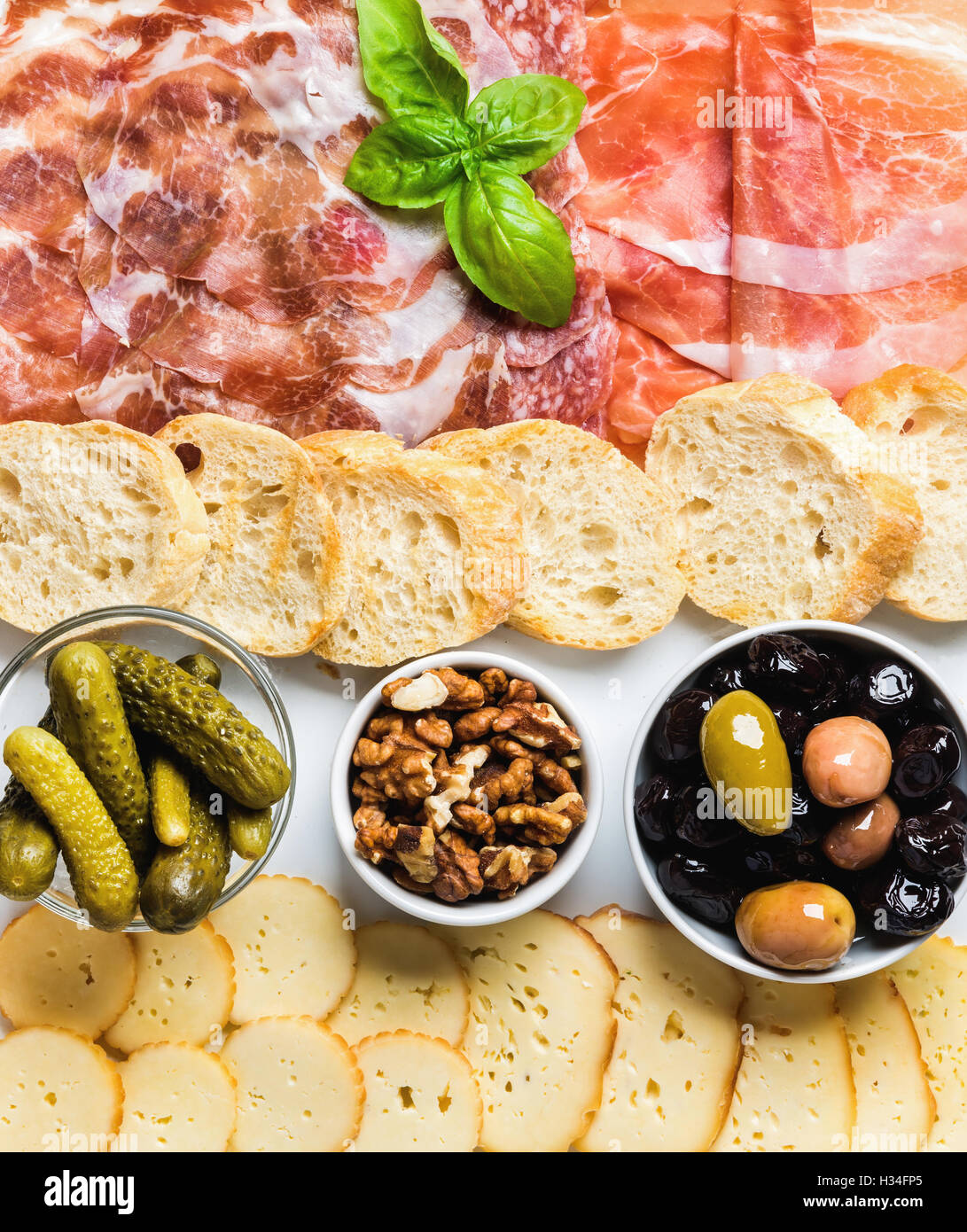 Meat and cheese snack set for wine on white background Stock Photo - Alamy