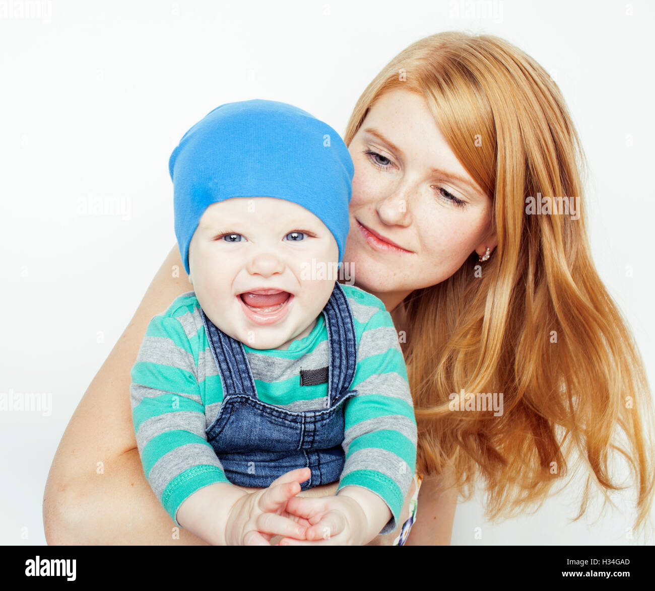young beauty mother with cute baby, red head happy modern family ...
