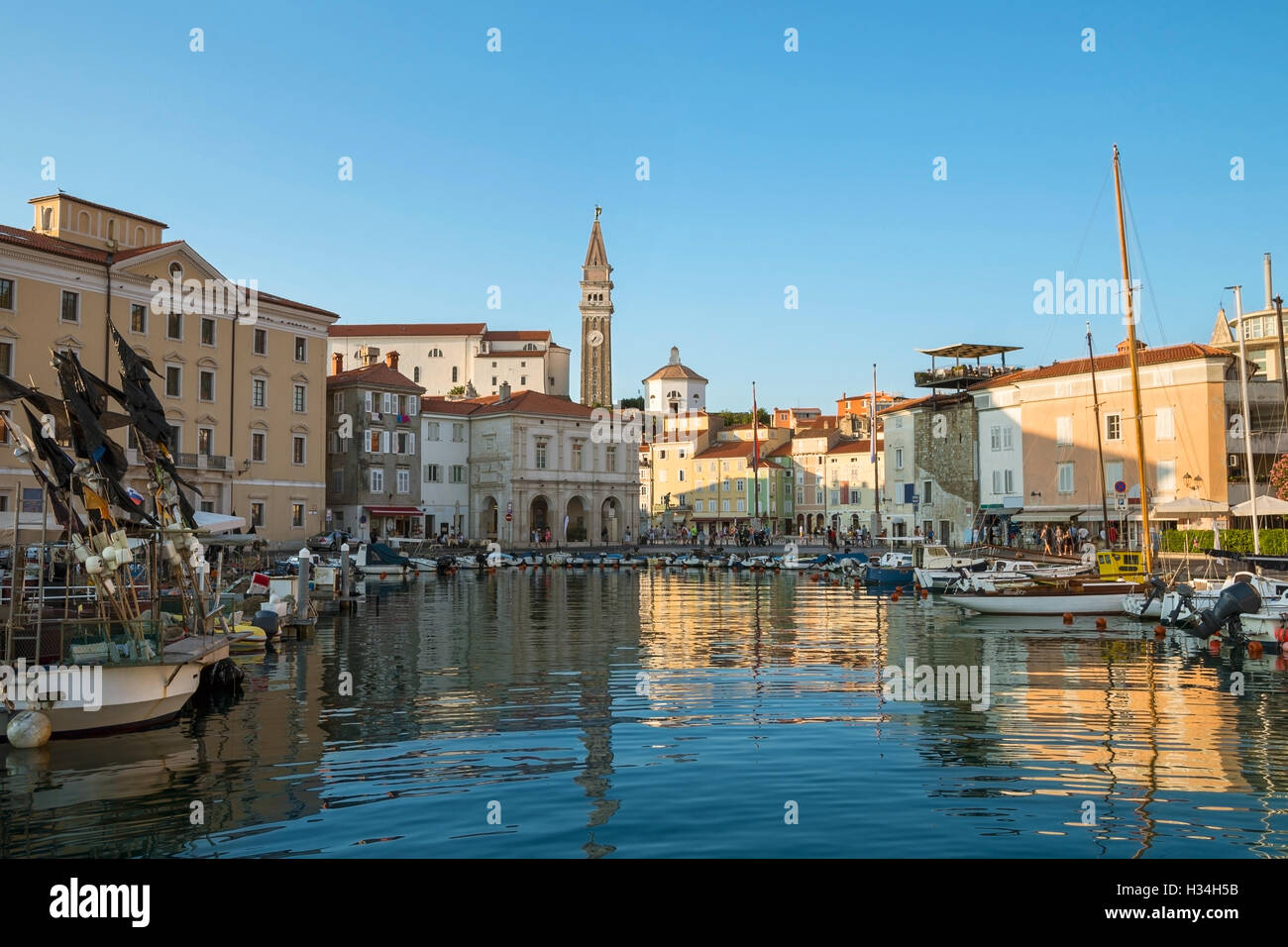 Port of Piran with boats and Church of St. George in background ...