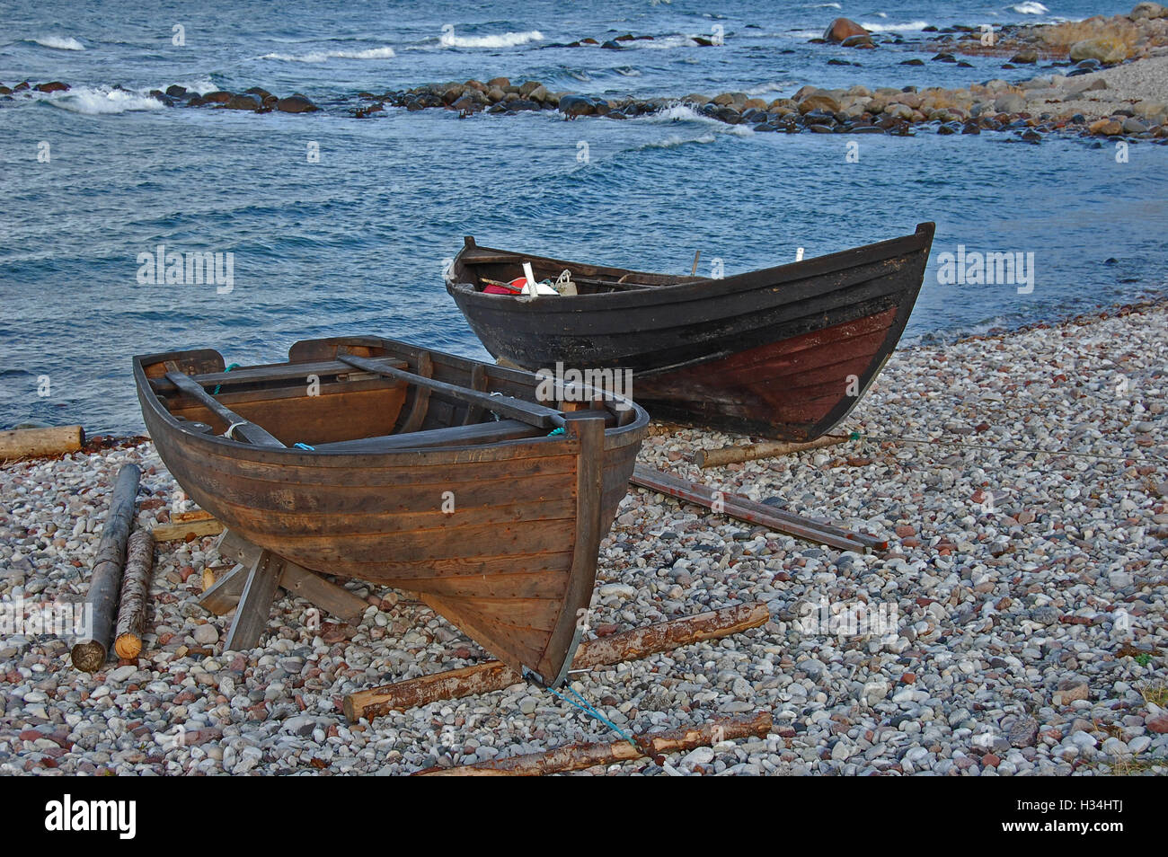 Two skiffs on the pebble beach by the sea Stock Photo - Alamy