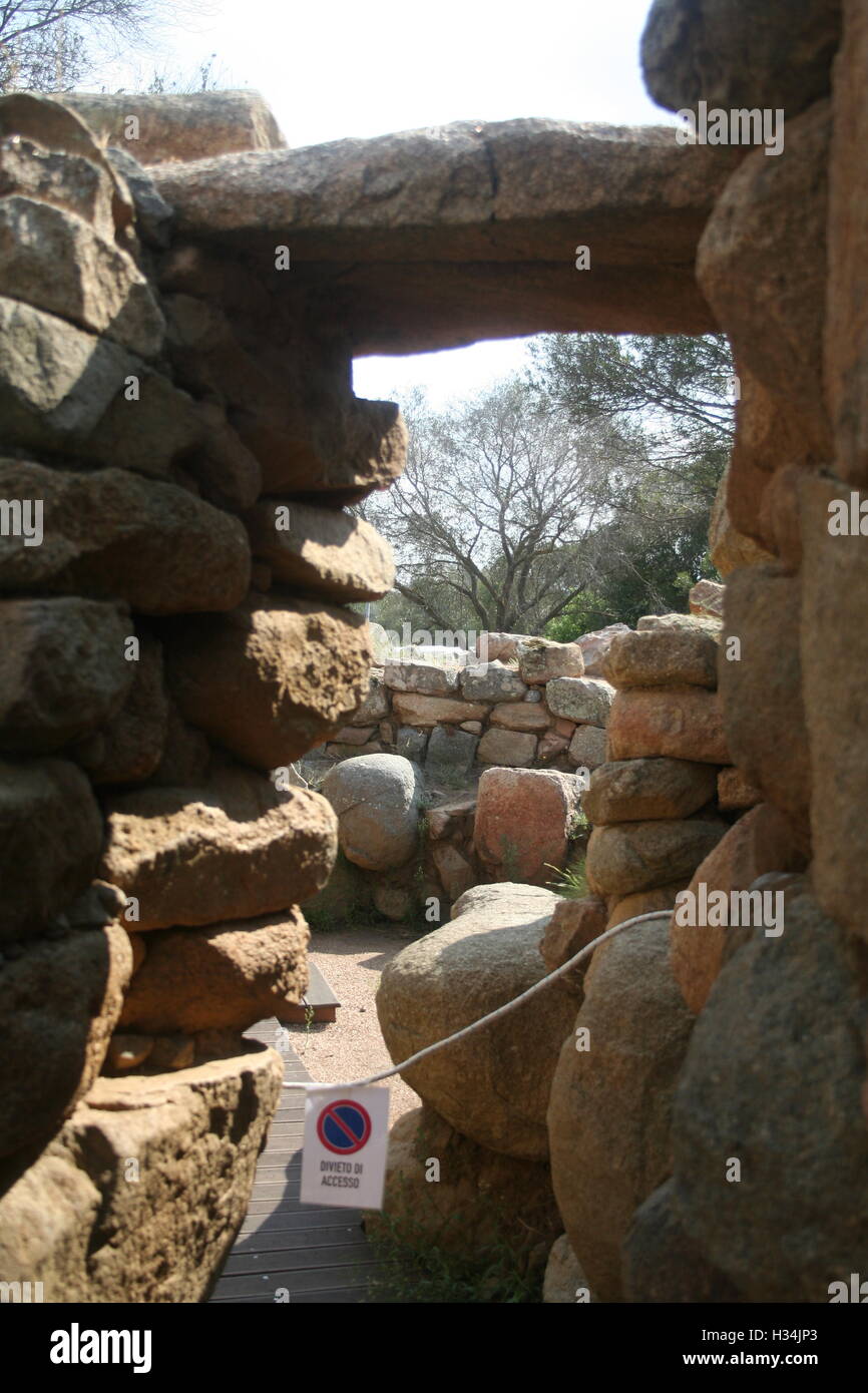 A stone build arch leading to a wooden path off limits, at an old ...