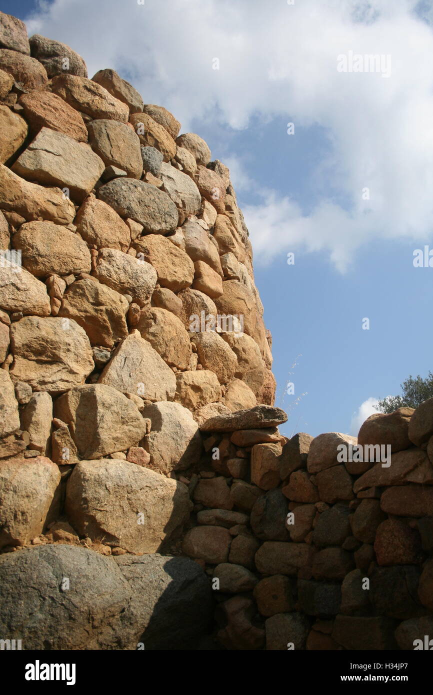 The side view of a tall stone built turret in an old castle in Sardinia ...