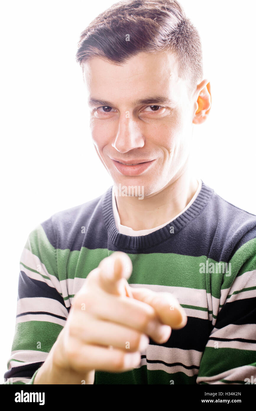 Portrait of a smart serious young man standing against white background ...