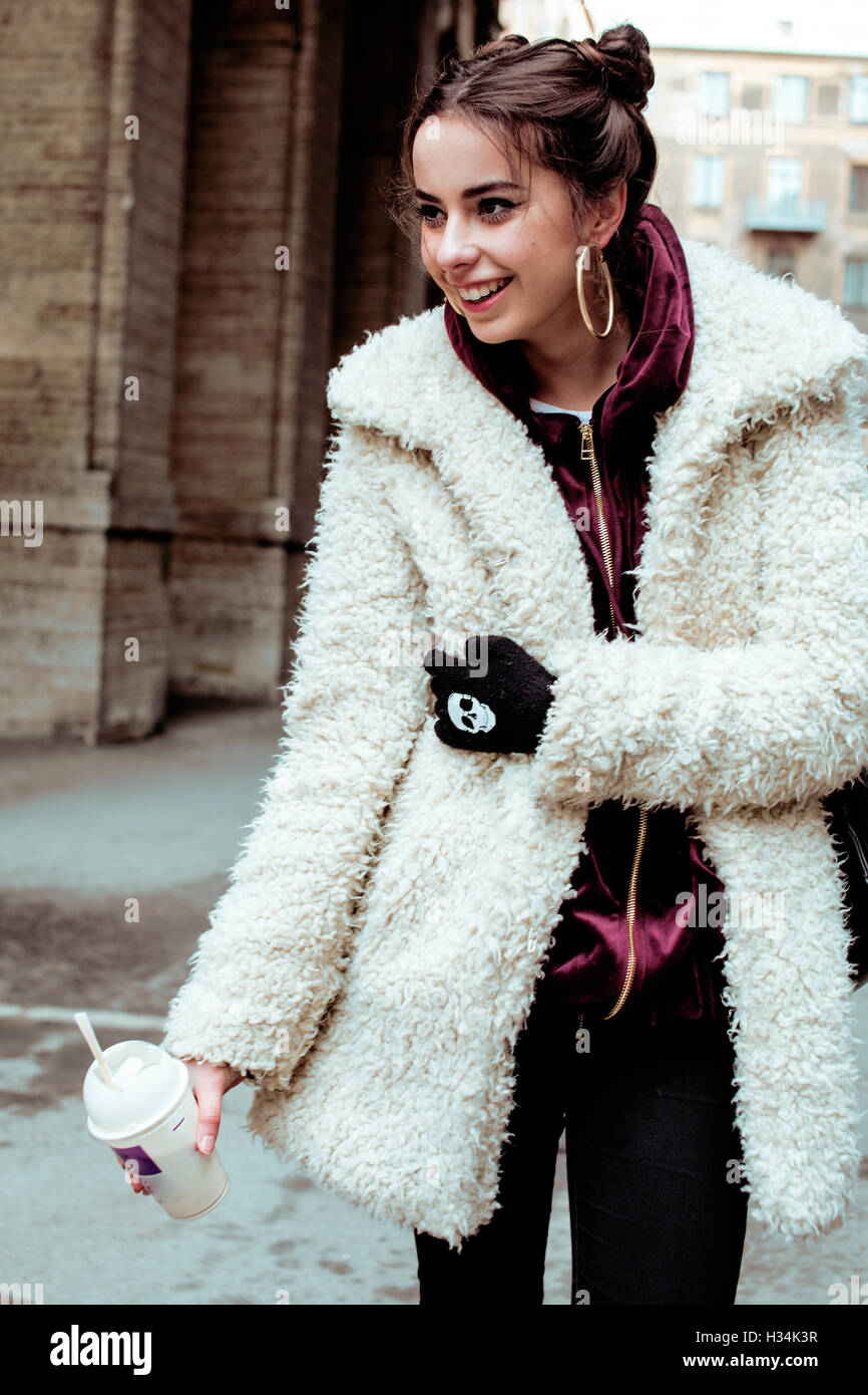 young pretty stylish teenage girl outside on city street fancy fashion ...