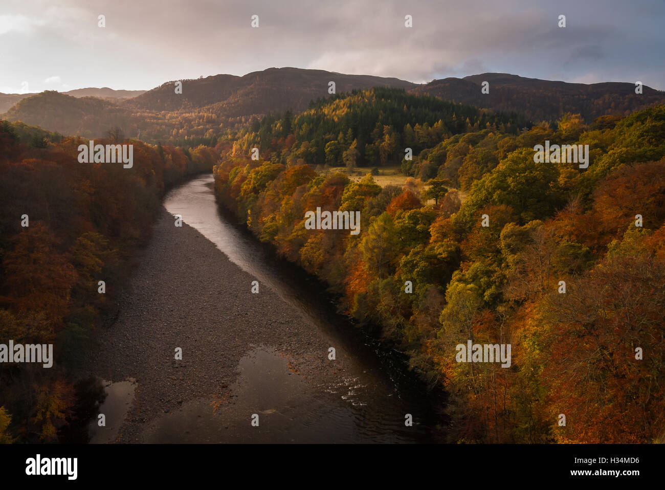 Looking down on the River Garry with the Autumnal trees lining it's ...