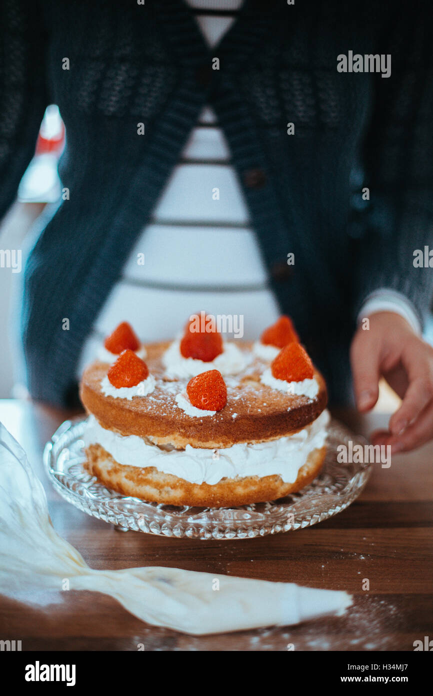 Woman with a beautiful baked cake Stock Photo - Alamy