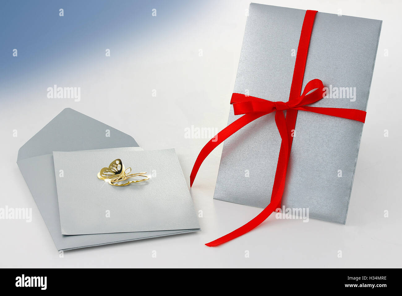 Grey envelope with jewelery brooch on white background Stock Photo - Alamy