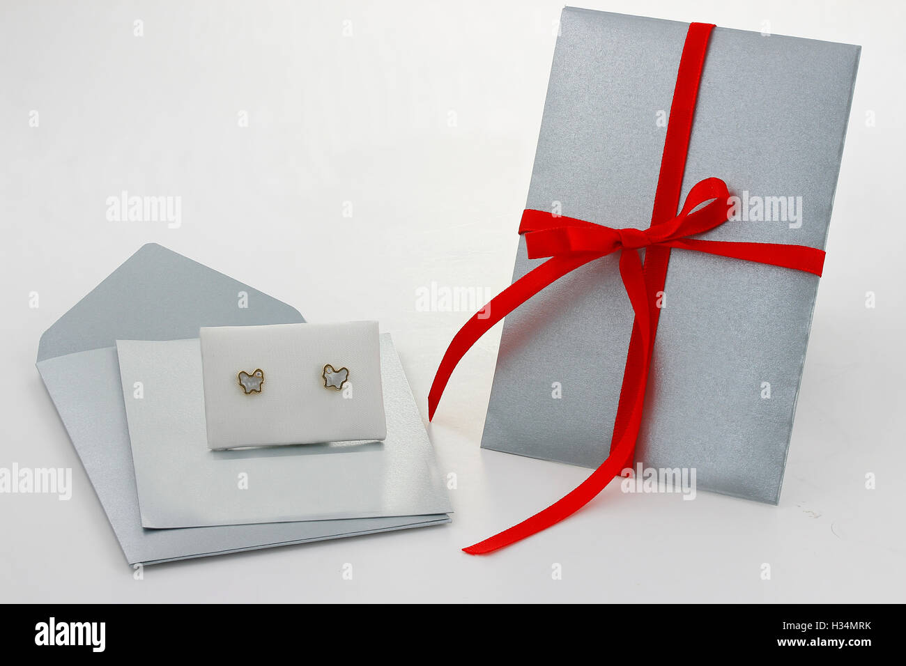 Grey earrings hi-res stock photography and images - Alamy