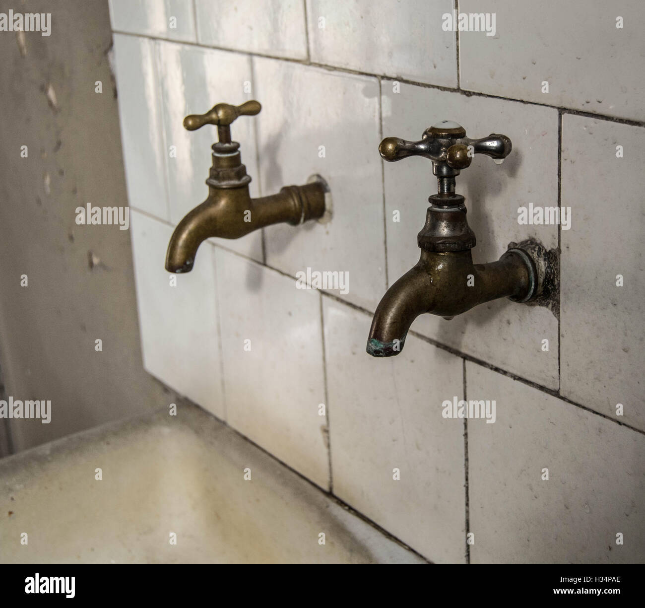 Two old faucets next to each other Stock Photo - Alamy
