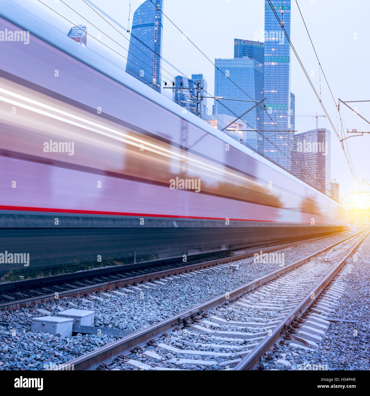 Modern high-speed train moves fast on the business center background ...