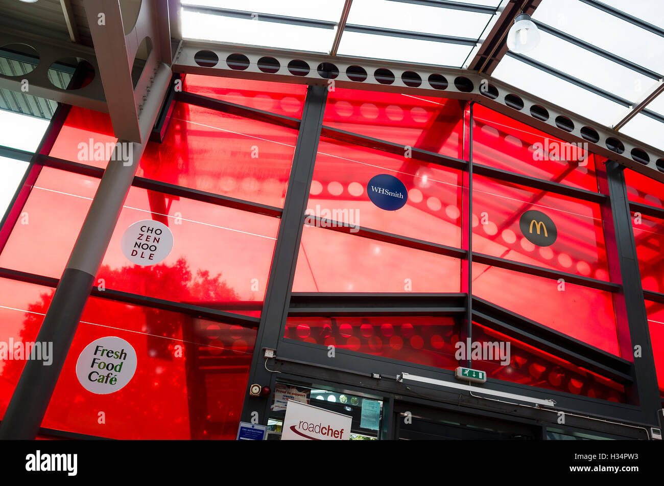 Red glass panels make a striking feature above the entrance to a ...