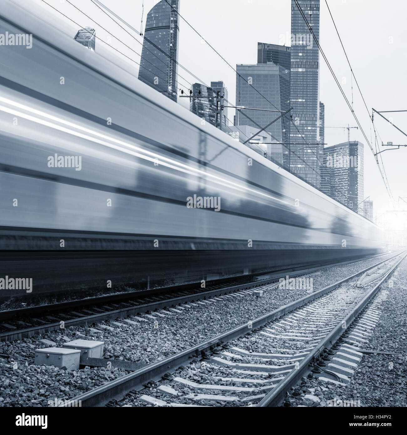 Modern high-speed train moves fast on the business center background ...