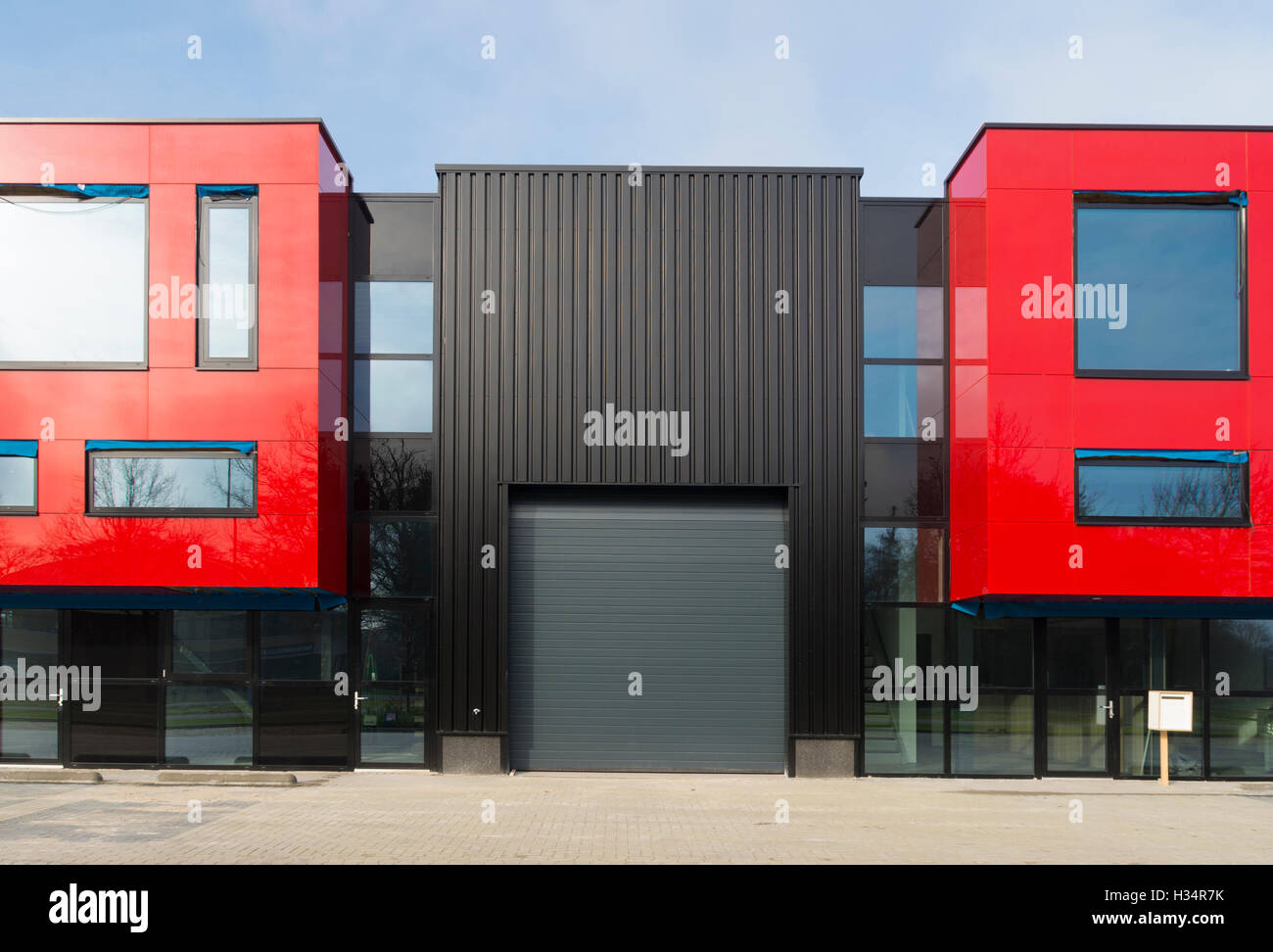 newly build red industrial warehouse with offices Stock Photo - Alamy
