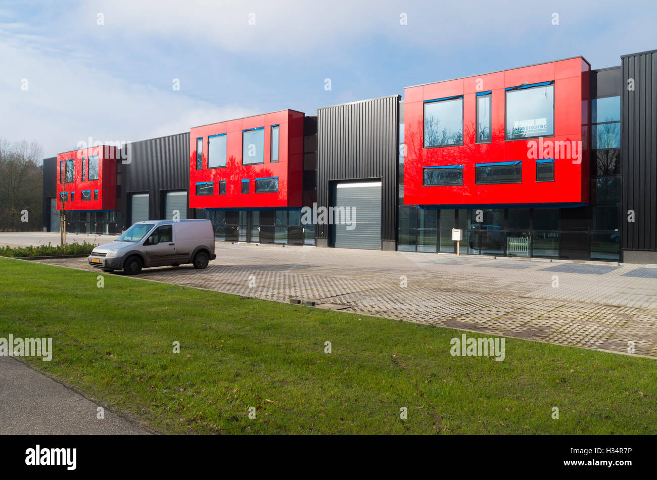 newly build red industrial warehouse with offices Stock Photo - Alamy