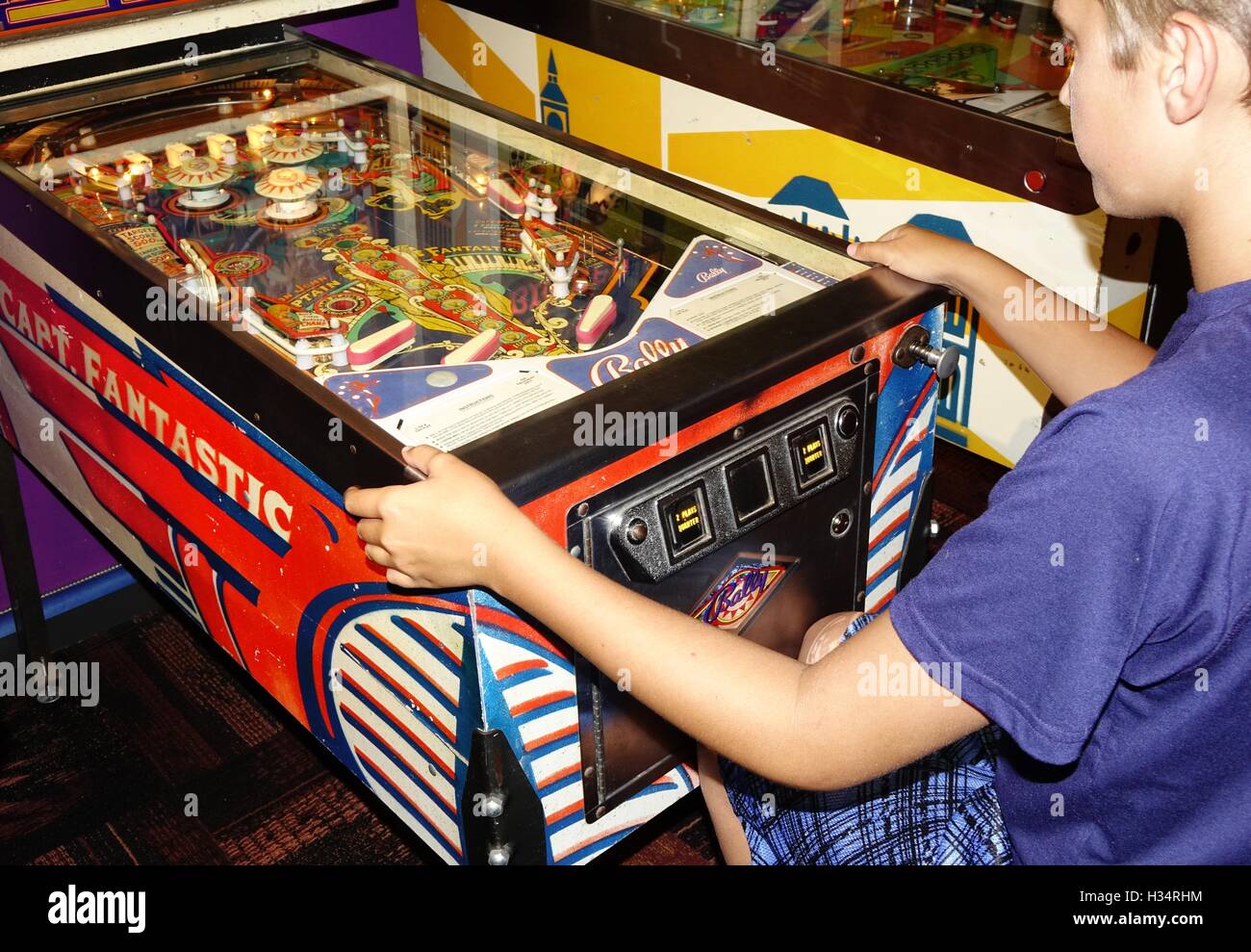 Young man enjoying a game at the Pinball Museum, Center in the Square ...