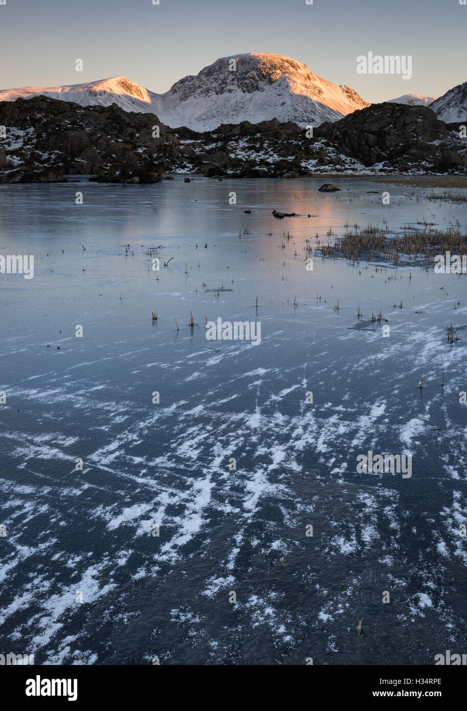 Dusk sunlight on Great Gable above a frozen Innominate Tarn, Haystacks ...