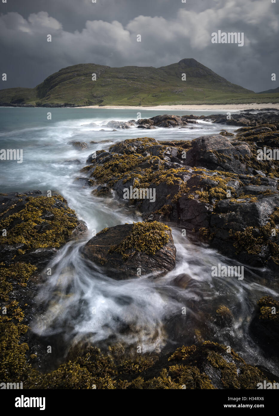 Swirling tide and Beinn Chliaid, Isle of Barra, Outer Hebrides Stock ...