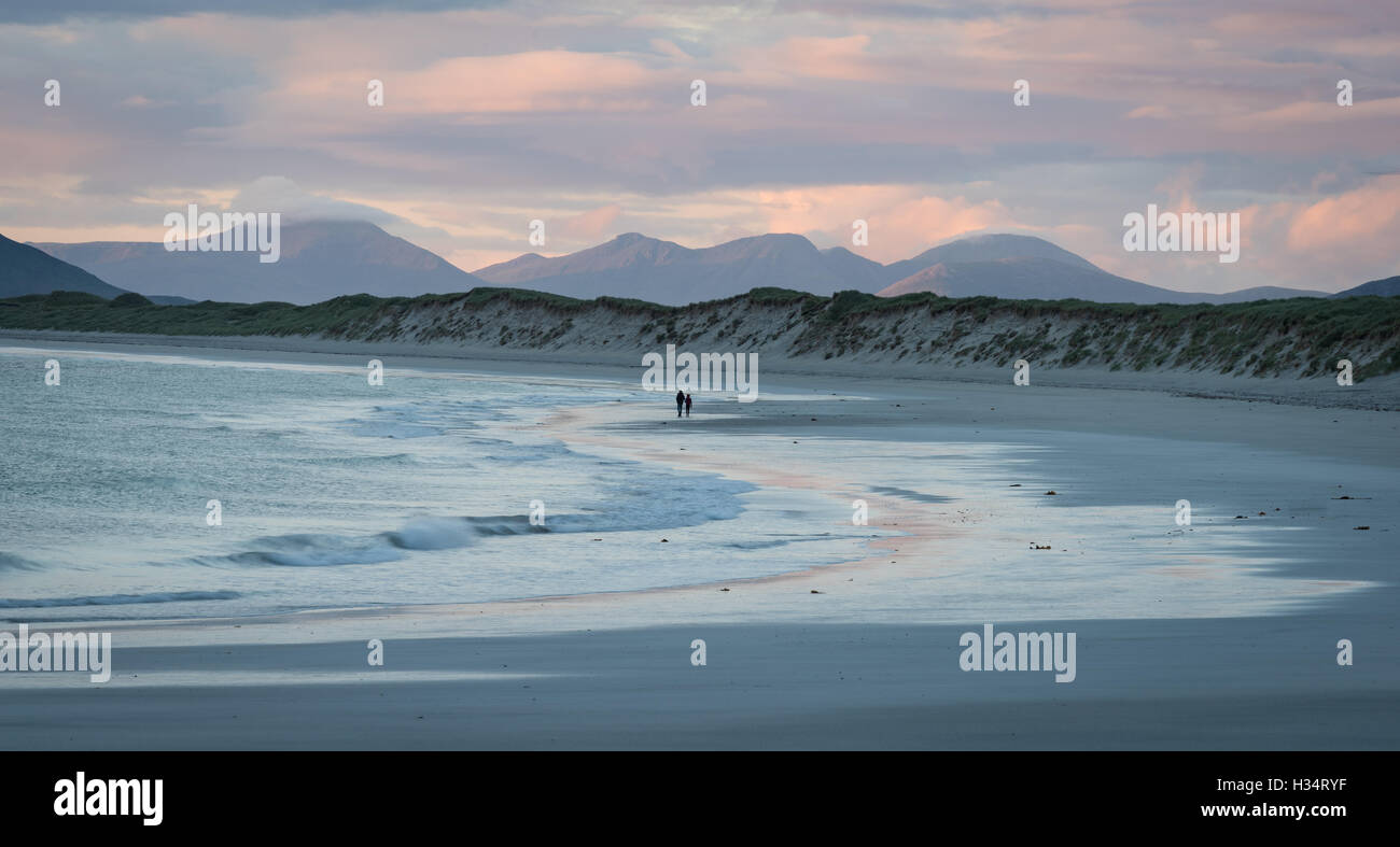 Couple on West Beach Berneray at dusk, Outer Hebrides, Western Isles ...