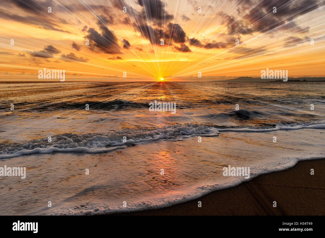 Sunset ocean rays is a bright burst of sun beams on the ocean horizon ...