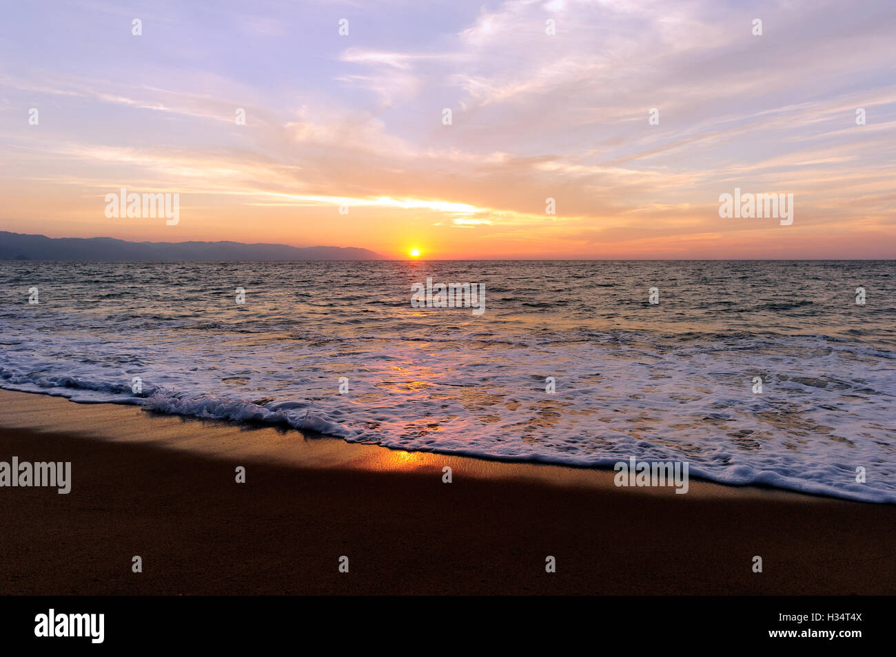 Ocean sunset is a brightly lit golden seascape with a gentle wave ...