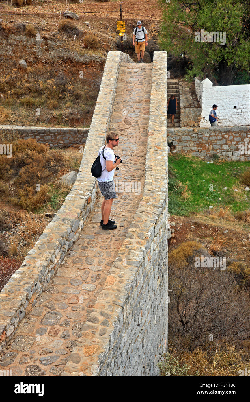 Old stone arched bridge at Vlychos village, Hydra island, Attica ...