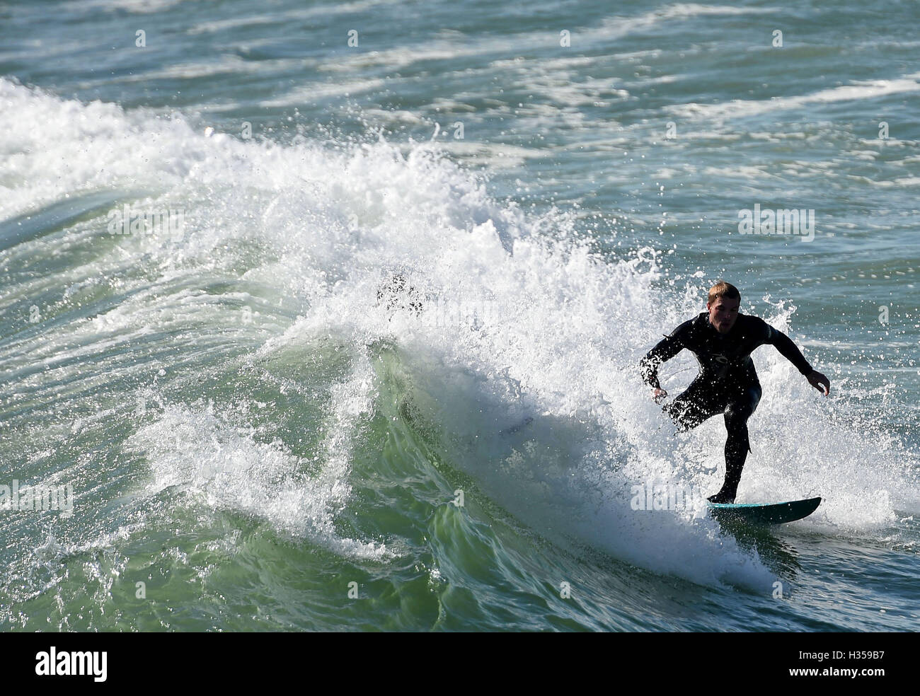 Surfers surfing at Bournemouth Beach, Dorset, UK Stock Photo - Alamy