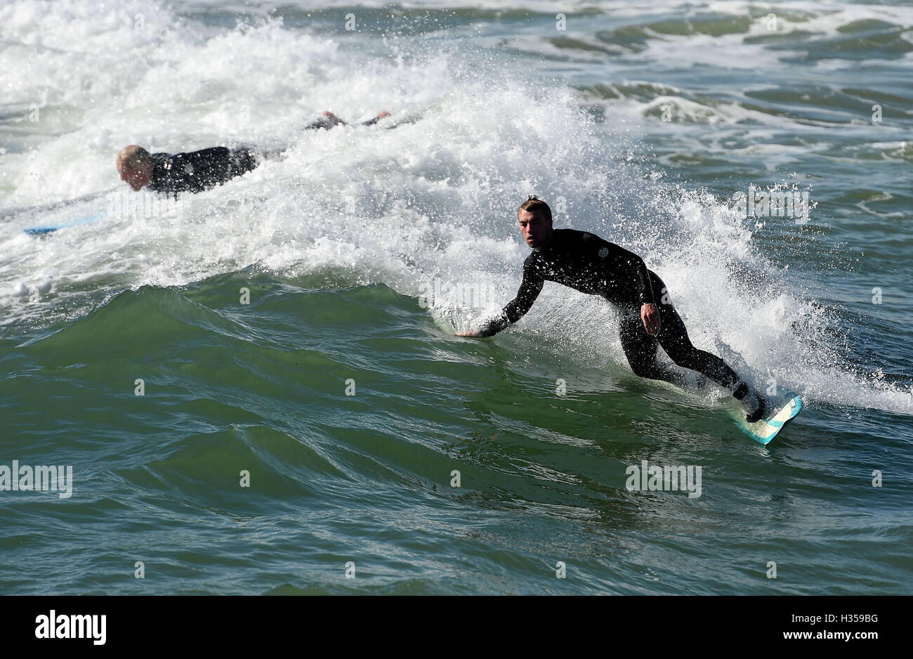 Surfers surfing at Bournemouth Beach, Dorset, UK Stock Photo - Alamy