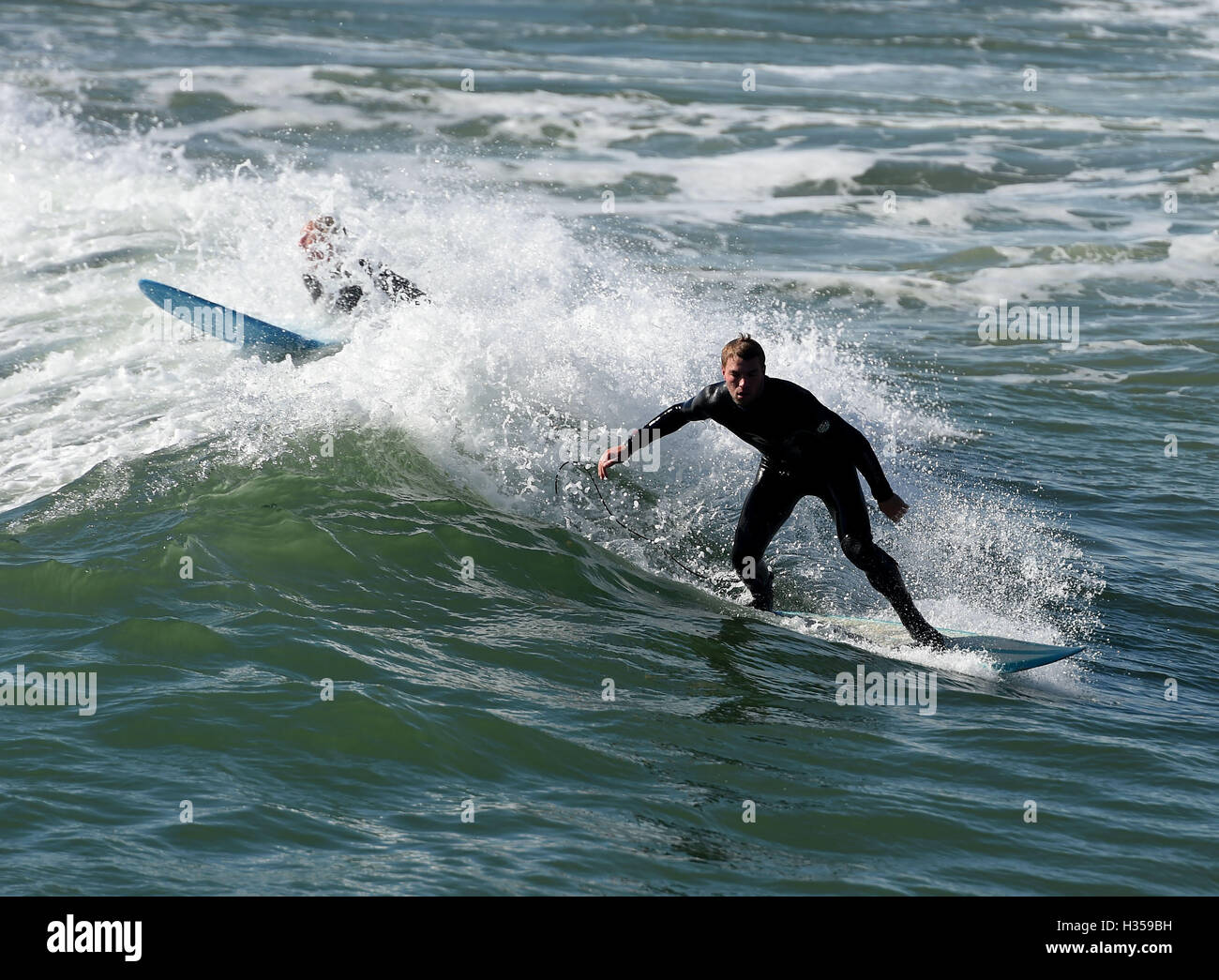 Surfers surfing at Bournemouth Beach, Dorset, UK Stock Photo - Alamy