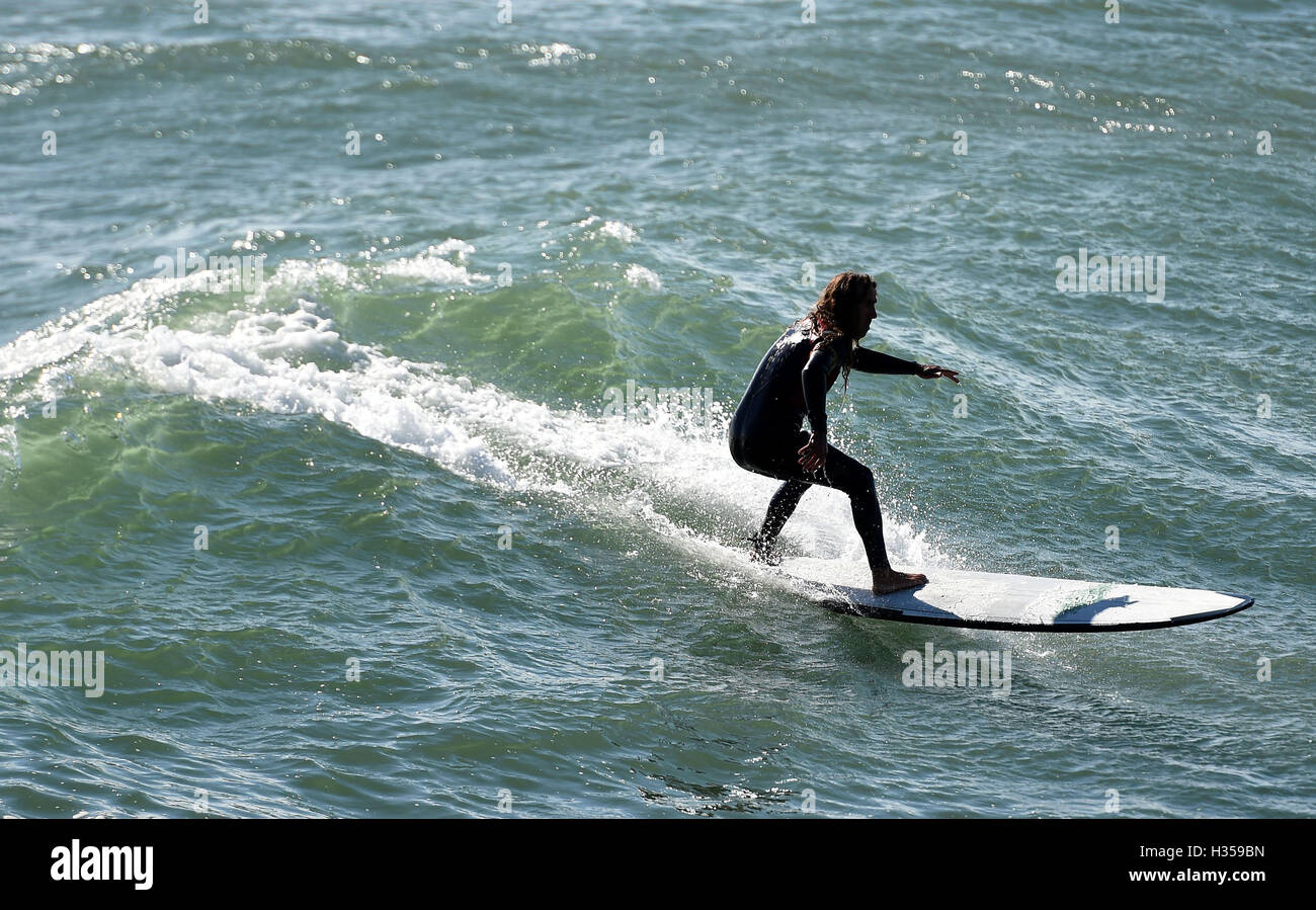 Surfers surfing at Bournemouth Beach, Dorset, UK Stock Photo - Alamy