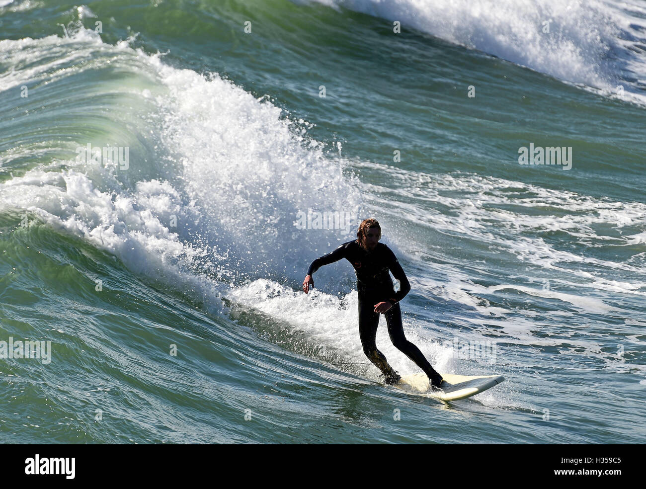 Surfers surfing at Bournemouth Beach, Dorset, UK Stock Photo - Alamy
