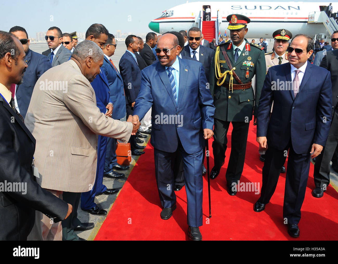 Cairo, Egypt. 5th Oct, 2016. Sudanese President OMAR AL-BASHIR greets officials as he walks with ...