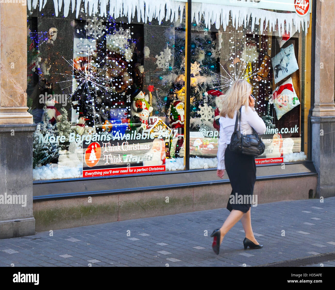 People passing shop windows of business retail fashion stores in the ...