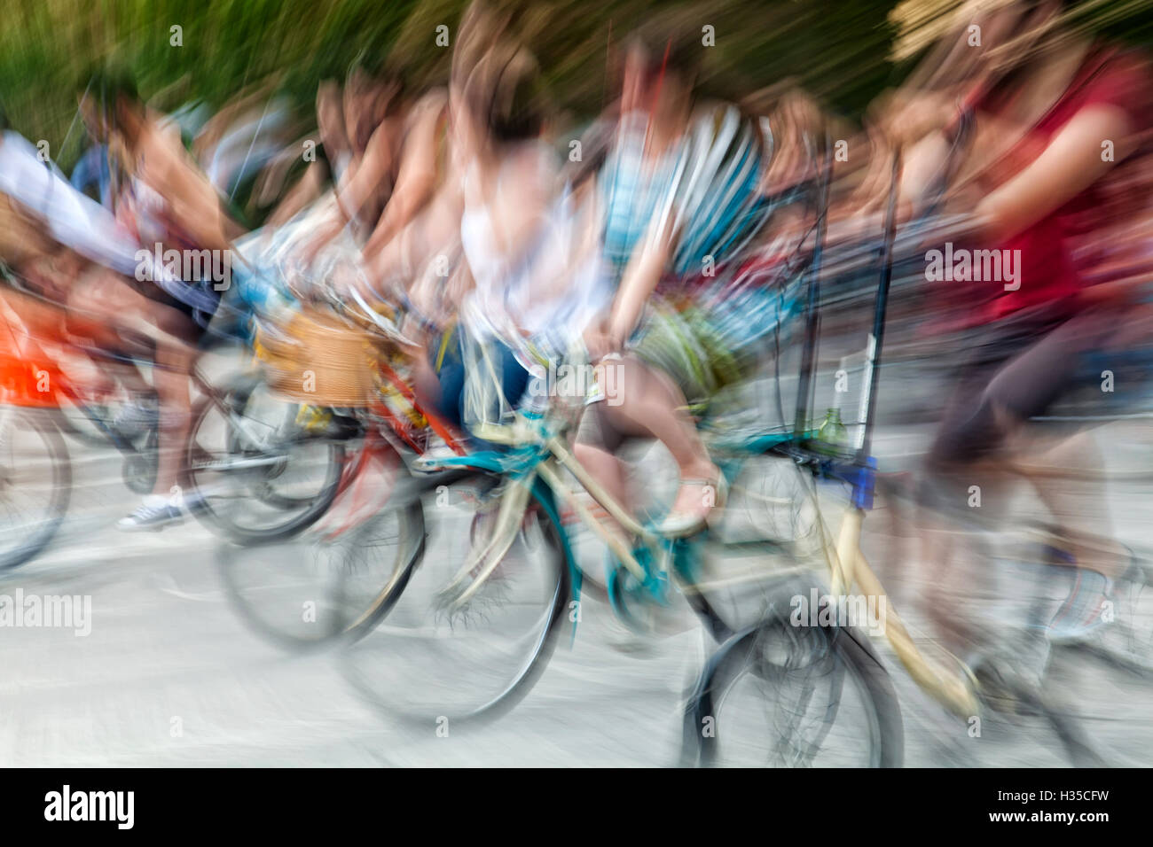 Zooming in picture with cyclists on their bikes. Abstract image ...